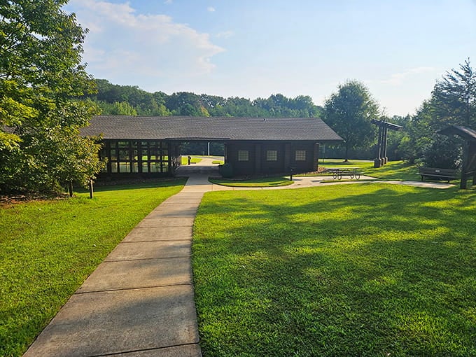 Morning light bathes the visitor center in golden warmth, where manicured lawns meet wild forests in perfect harmony and balance.