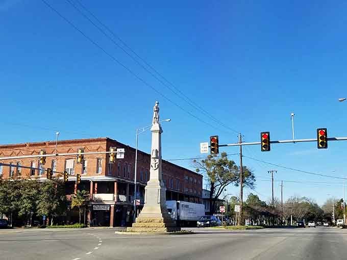 That white monument rises proudly at the intersection, marking history while modern life flows peacefully around it.