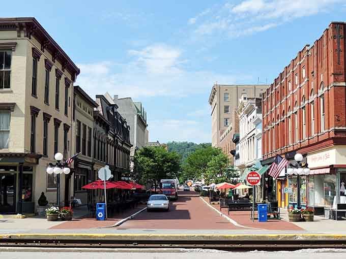 Red umbrellas dot the pedestrian mall like cheerful mushrooms, inviting you to linger without draining your wallet dry.