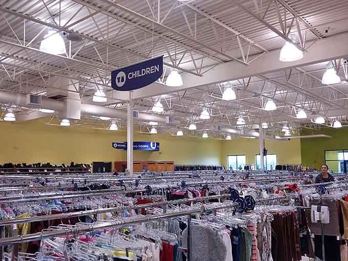 That impressive children's section sign overhead guides families to organized racks filled with affordable clothing for growing kids.