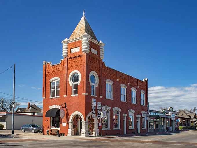 That striking red brick corner building commands attention with its tower, standing guard over the historic town square.