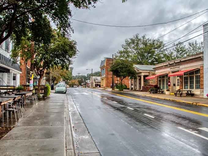 Rain-slicked streets reflect stormy skies, giving this charming downtown an atmospheric quality worthy of any movie set.