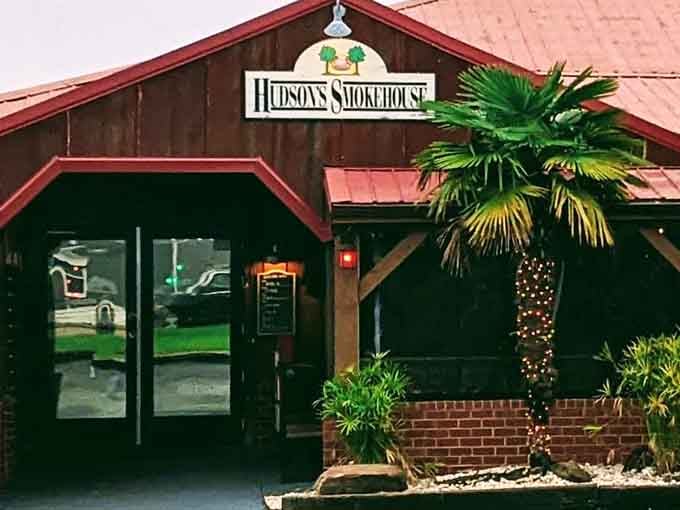 The wooden beams and palm tree outside Hudson's create that perfect "discovered a hidden gem" feeling before you even taste the smoked meats.