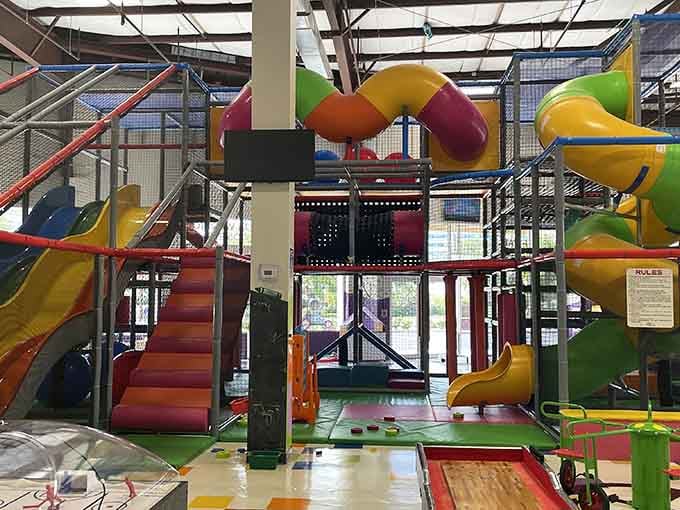 The towering play structure stands like a monument to childhood fun, with bridges connecting adventures at every level.