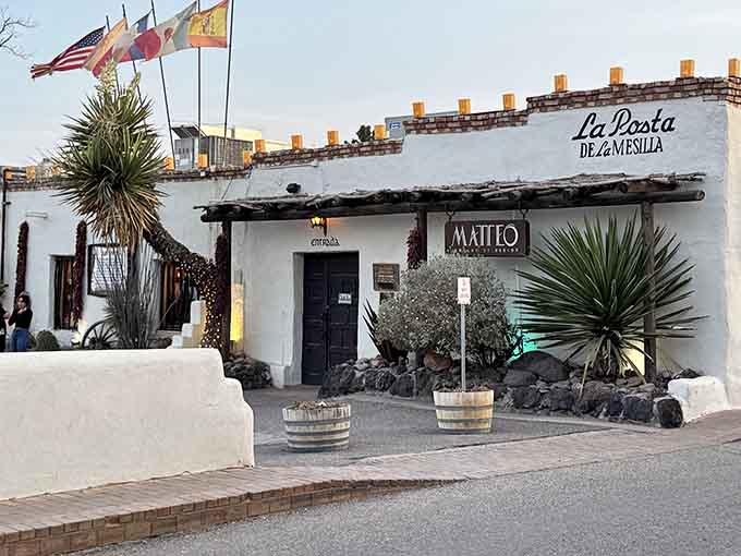 Flags flutter above La Posta's entrance, marking this historic building as a true New Mexican treasure. Centuries of hospitality in every bite!