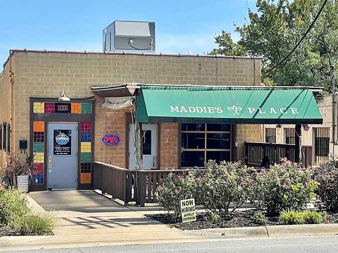 Small but mighty! Maddie's colorful facade and wooden deck invite you to sit a spell and savor some New Orleans magic in Little Rock.