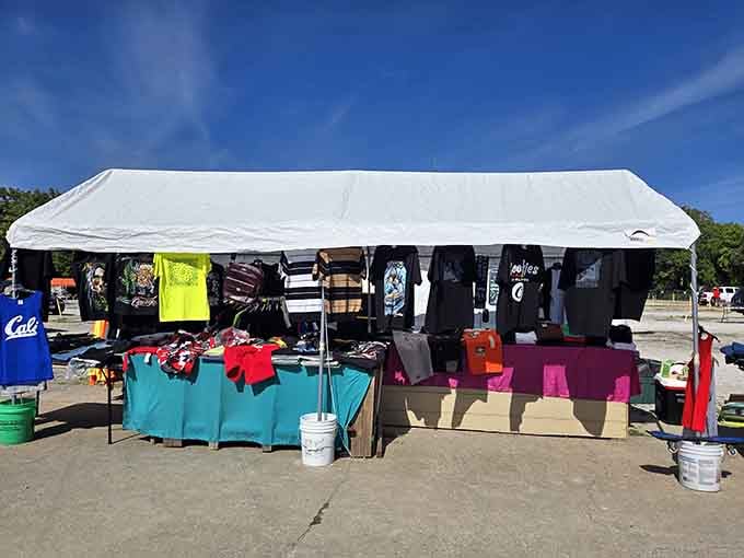 Colorful merchandise spills across tables beneath white tents, creating a vibrant outdoor shopping experience for everyone.