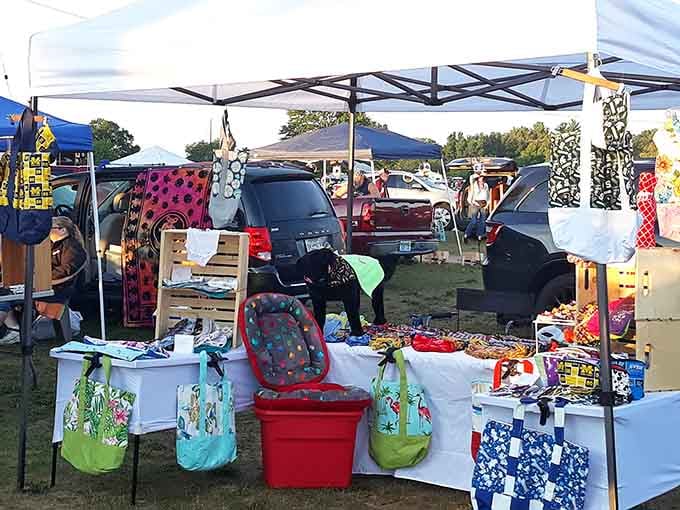 Colorful tote bags and handmade crafts pop against white tables like a rainbow after spring rain.