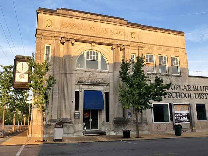 The old bank building's ornate stonework and towering entrance speak to an era when architecture meant something beyond just function.