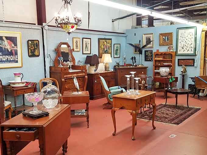 Antique treasures fill a curated booth that looks like your grandmother's house if she collected everything beautifully.