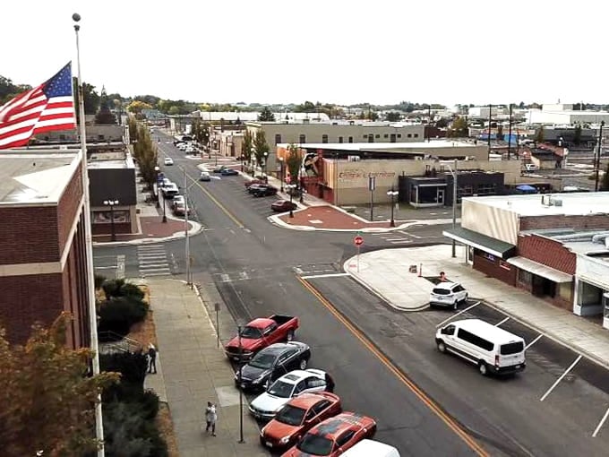 That American flag waves proudly over a main street that looks like it stepped out of a simpler time.