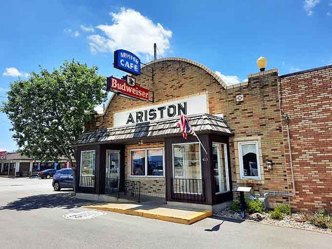 Bright sunshine illuminates the iconic Ariston name, a beacon for road-trippers seeking authentic American roadside dining.