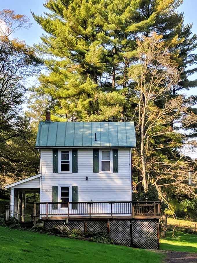 Golden afternoon light bathes this simple house, making it look peaceful despite the dark tales attached to its past.