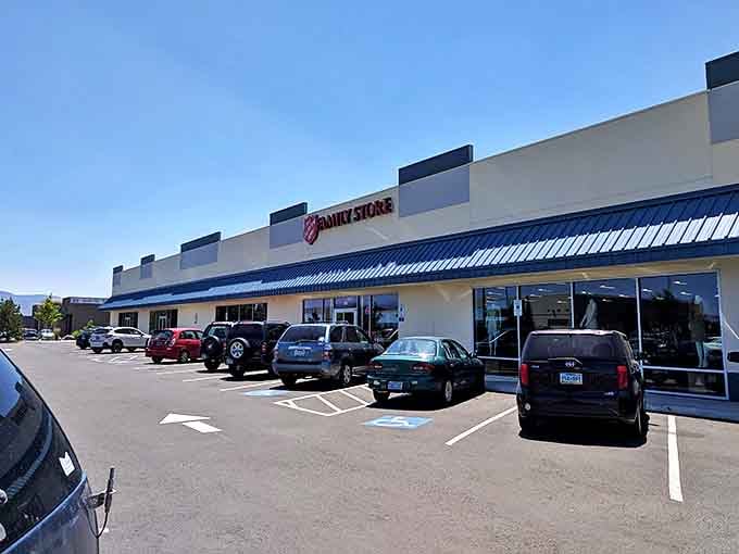 Sunshine bathes the Salvation Army store, where rows of cars suggest the treasures waiting inside.