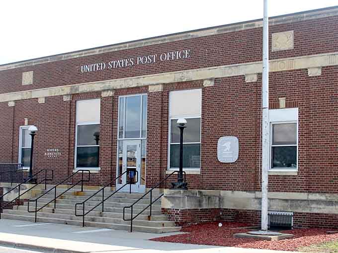 Red pipestone architecture glows warmly in the sunlight, creating a town that literally looks different from anywhere else.