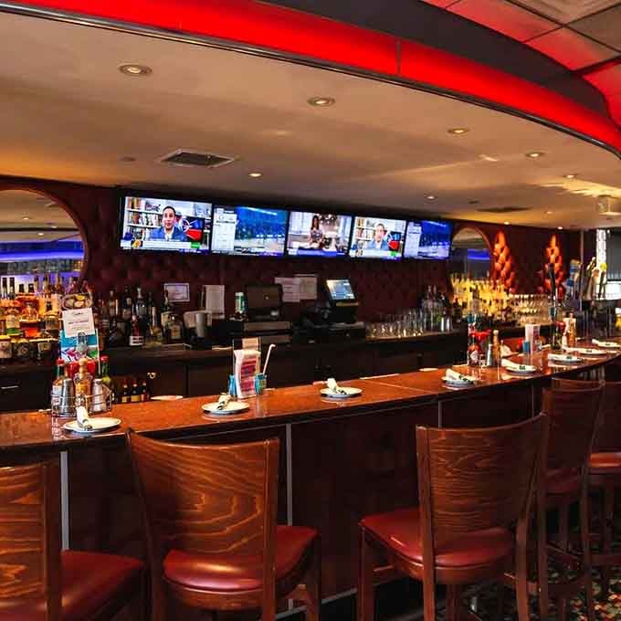 The bar area—where "I'll just have coffee" often transforms into "and maybe a Bloody Mary too" because some mornings require reinforcements.