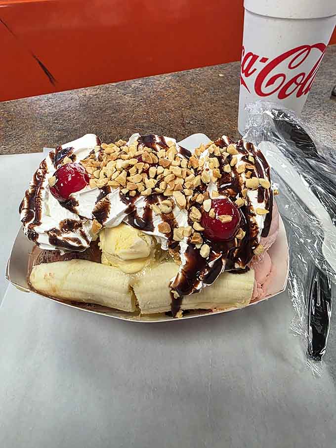 A banana split that makes you question whether dessert should come with assembly instructions and a map.