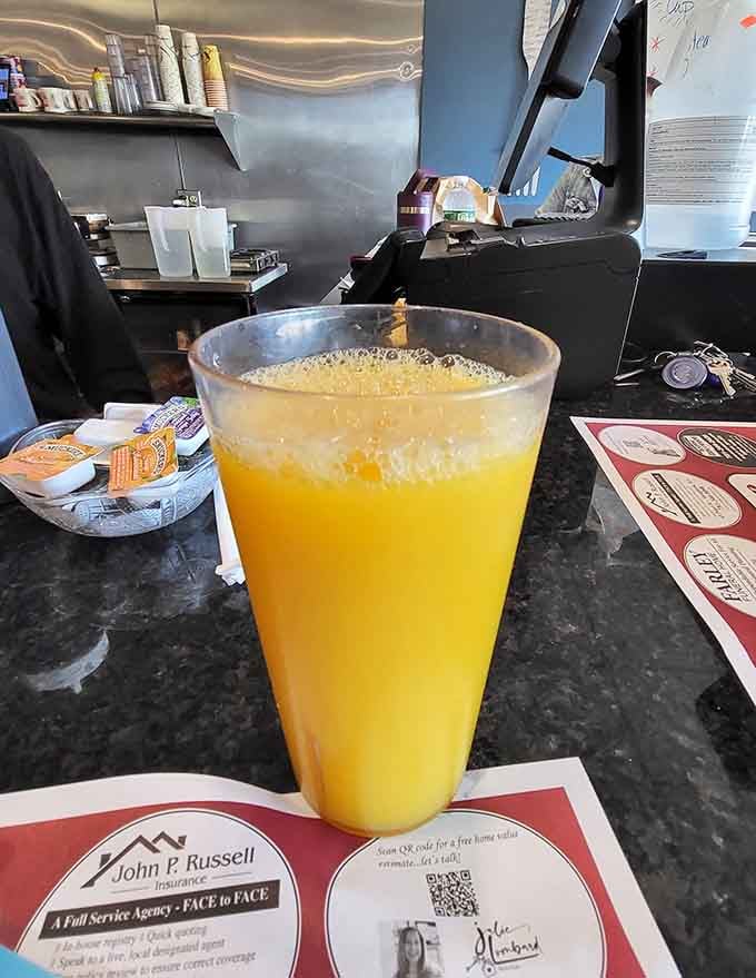 Fresh orange juice so bright and inviting, it practically glows with vitamin C and morning optimism at the counter.