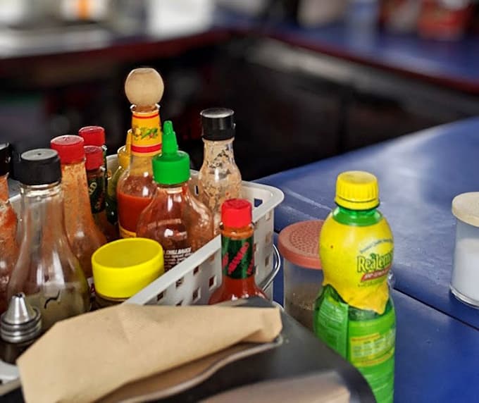 A condiment collection that says "customize your experience" in the most delightfully casual way possible here.