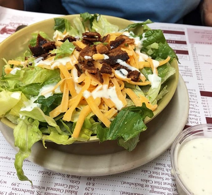 A salad so loaded with bacon and cheese it practically apologizes for the lettuce hiding underneath all that goodness.