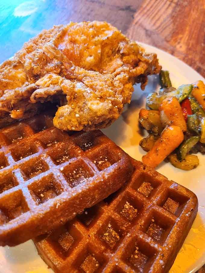 Chicken and waffles dusted with powdered sugar represent the kind of brunch dreams that make Sunday mornings worth waking up for.