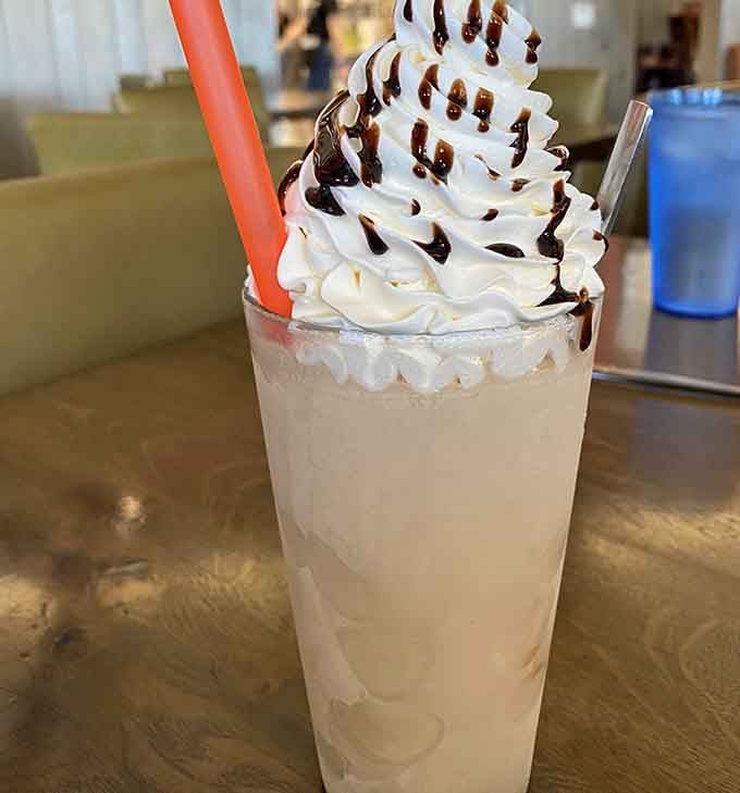 This isn't just a milkshake; it's a tower of creamy indulgence that makes you wonder why adulthood doesn't come with more whipped cream.