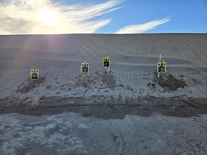Your adventure pauses at sandy targets lined across a dune, where you smile at patterns beneath a glowing sky together.