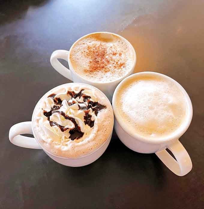 Three mugs of happiness, including one with whipped cream and chocolate. Morning just got significantly better.