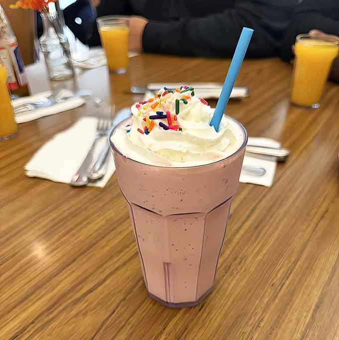 This milkshake topped with whipped cream and sprinkles is basically childhood in a glass.