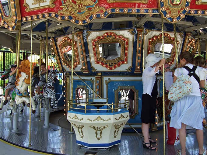 The ornate carousel spins dreams and memories, accessible to every child regardless of their mobility needs.