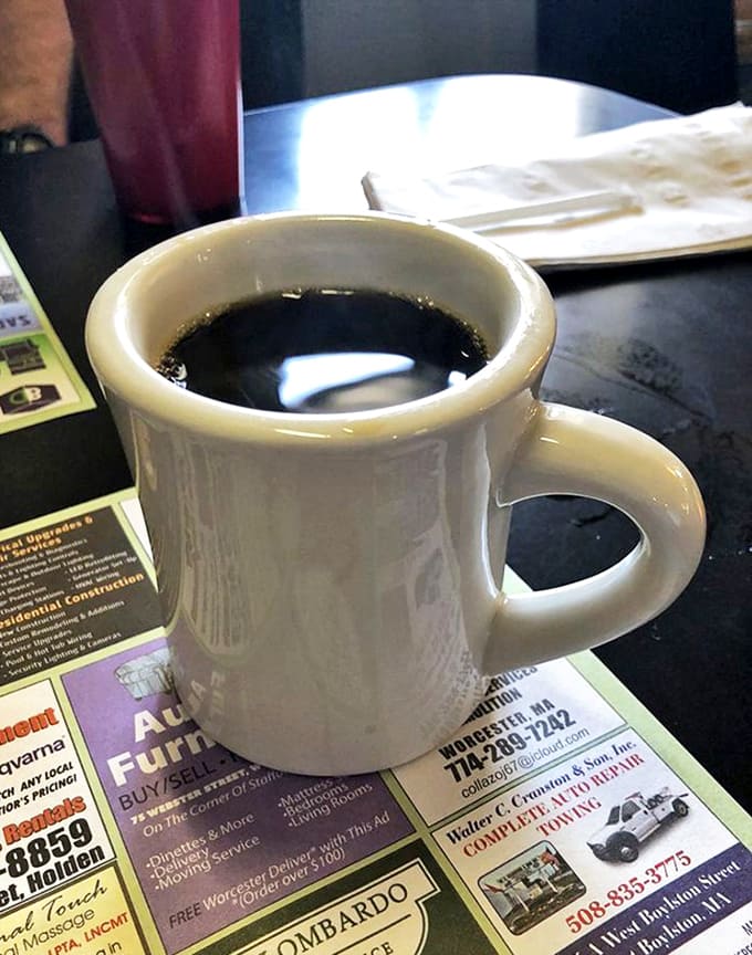 The humble diner coffee mug&mdash;delivering liquid motivation in ceramic form while resting on what appears to be the local newspaper's classified section.