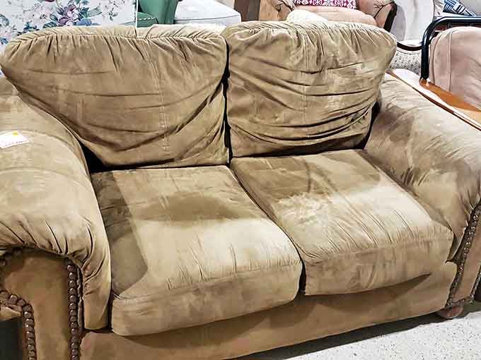 This loveseat has stories to tell, but with a little TLC, it's ready to be the cozy centerpiece of someone's living room.