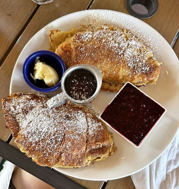 French toast that makes regular toast look like it's not even trying. Powdered sugar snowfall, butter melting like a summer romance.