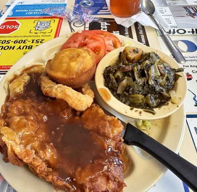 That pork chop sits atop perfectly seasoned turnip greens, proving vegetables can be just as exciting as the main event.
