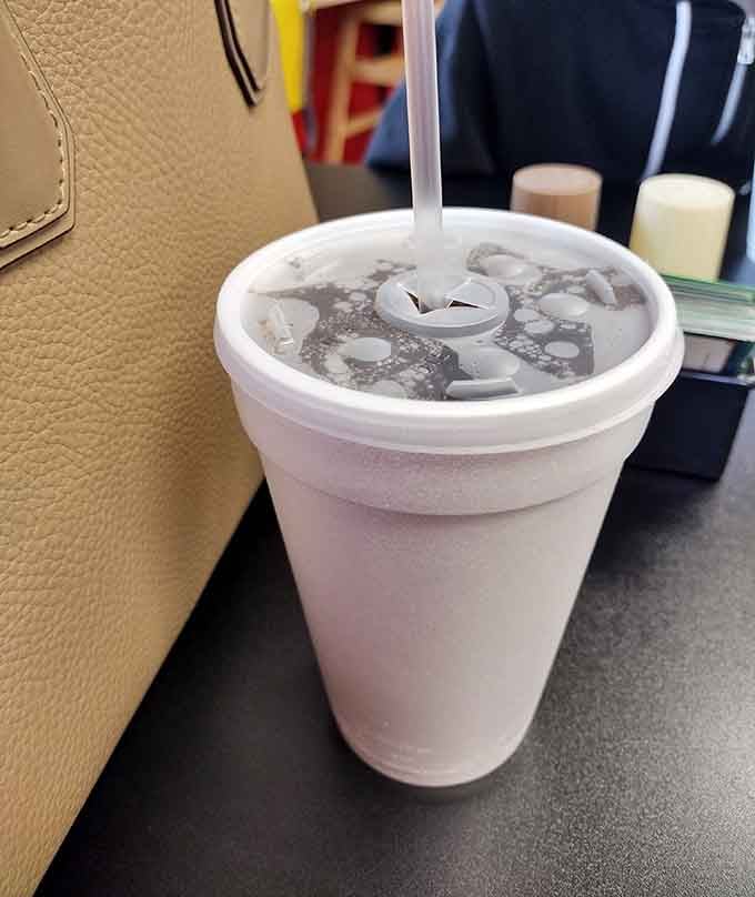 Ice-cold refreshment in a classic foam cup, because some traditions just make sense no matter the decade.