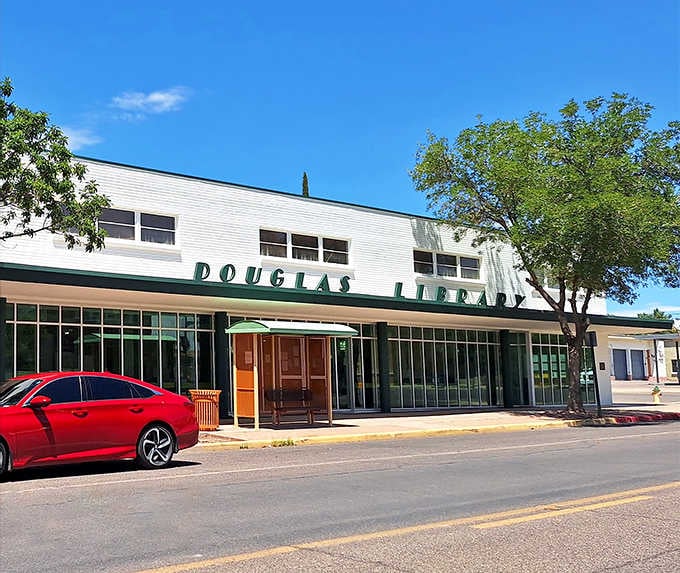 The Douglas Library's mid-century modern facade houses worlds of imagination behind its welcoming green lettering.
