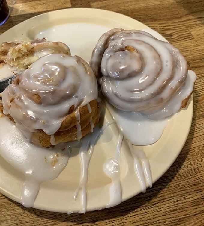Cinnamon rolls dripping with icing, the kind of morning pastry that makes alarm clocks slightly more tolerable.