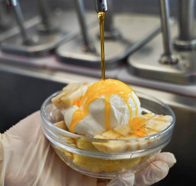 Caramel drizzle cascading over ice cream like liquid gold, because some moments demand dramatic presentation and extra napkins.