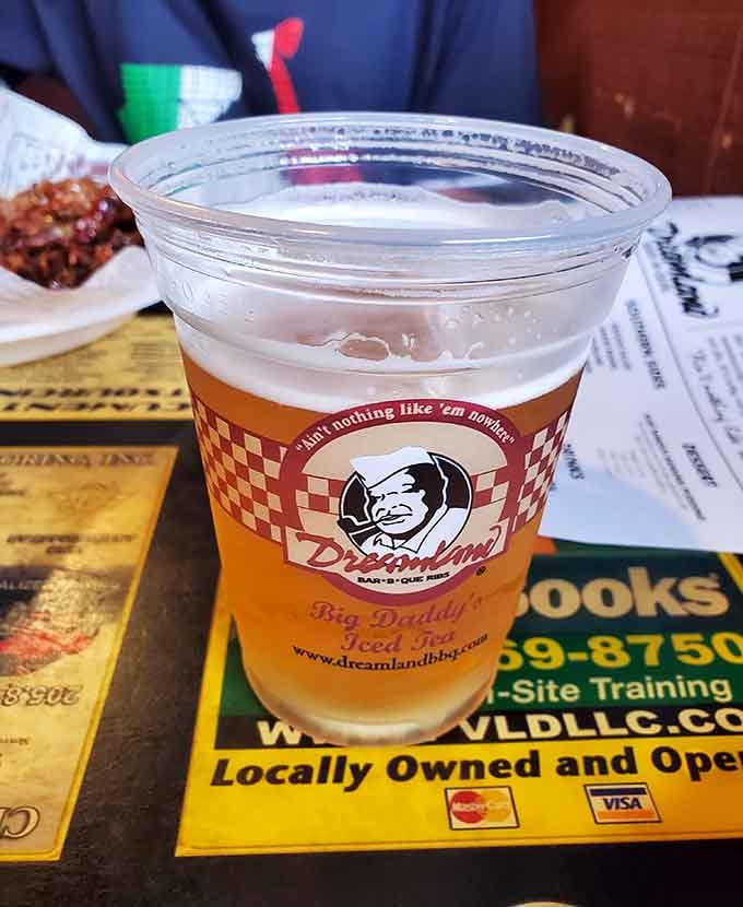 Even the cup knows what's up, proudly displaying the motto while holding whatever beverage helps you survive the heat.