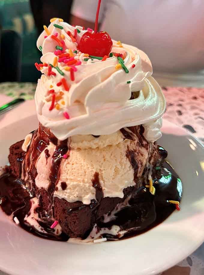 This brownie sundae situation with sprinkles and a cherry is basically childhood joy in dessert form, no apologies needed.