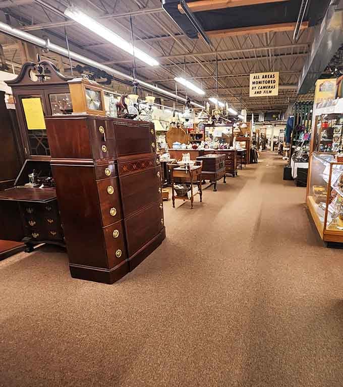 Rows of genuine wood furniture stretch endlessly, proving craftsmanship used to mean something beyond assembly instructions.