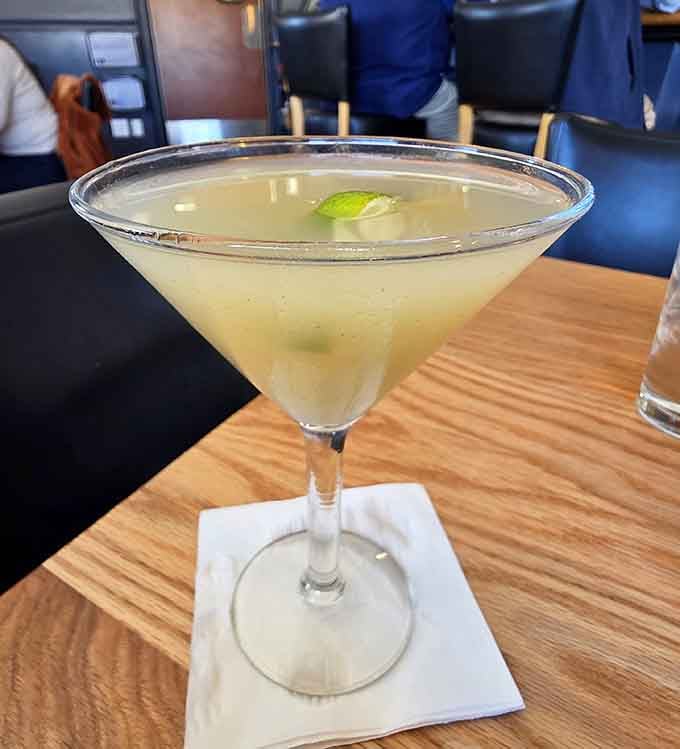 A perfectly crafted cocktail catches the light, promising to complement your seafood feast with sophisticated refreshment ahead.