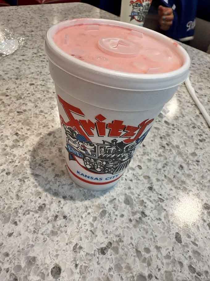 A strawberry shake in a Fritz's cup, thick enough to require actual effort through that straw, just like shakes should be.