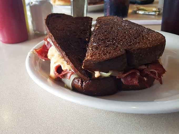 The Reuben sandwich stacked high with corned beef, looking like it could solve all of life's problems simultaneously.
