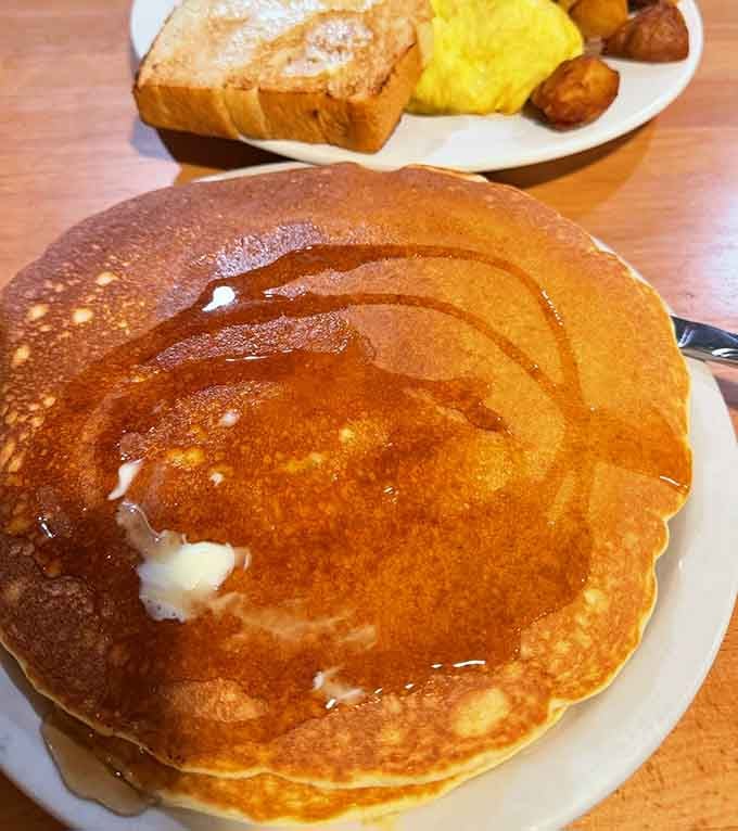 Pancakes so big they could double as frisbees, dripping with syrup and served with zero apologies for the carb count.