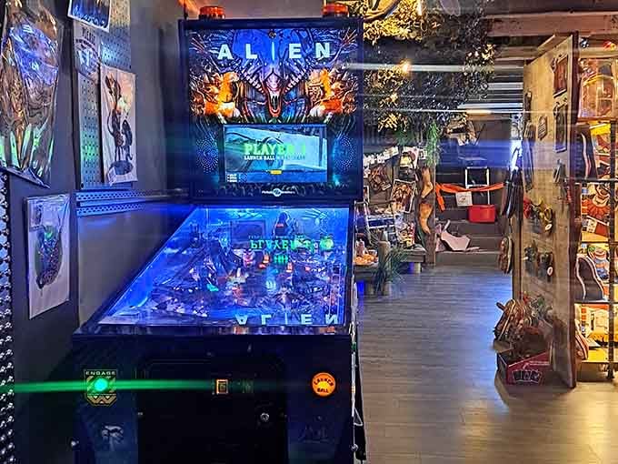 An Alien pinball machine stands ready because apparently horror fans also appreciate quality arcade entertainment.
