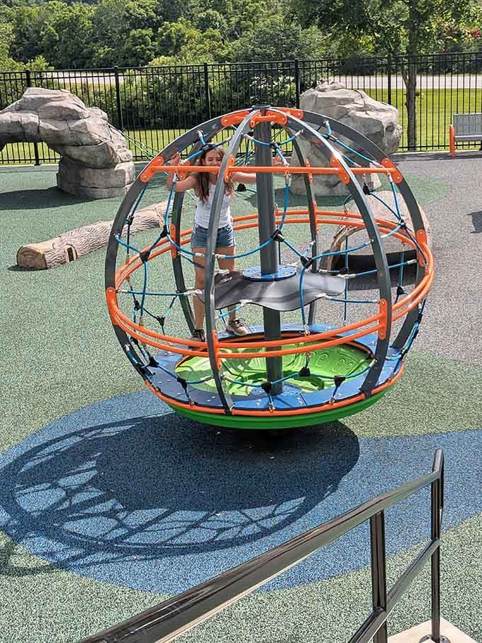 The orange sphere climber spins like a hamster wheel designed by NASA engineers with imagination.