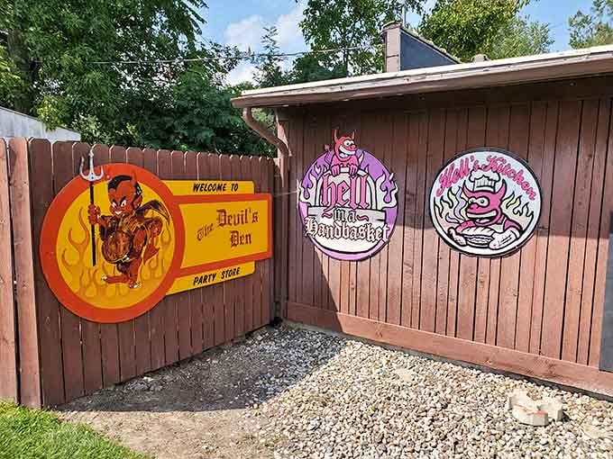 The Devil's Den party store sits behind colorful signs, making Hell look surprisingly festive for a place of eternal torment.