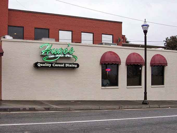 Hugo's neon sign glows with the promise of "Quality Casual Dining"&mdash;three words that speak directly to my soul and stomach. Those red awnings practically wink at hungry passersby.