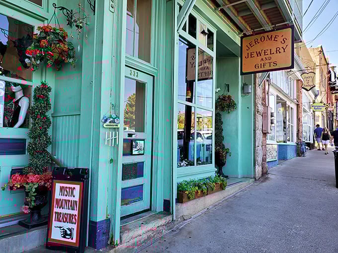 Charming storefronts painted in cheerful turquoise invite you to discover handcrafted treasures and local artistry inside.